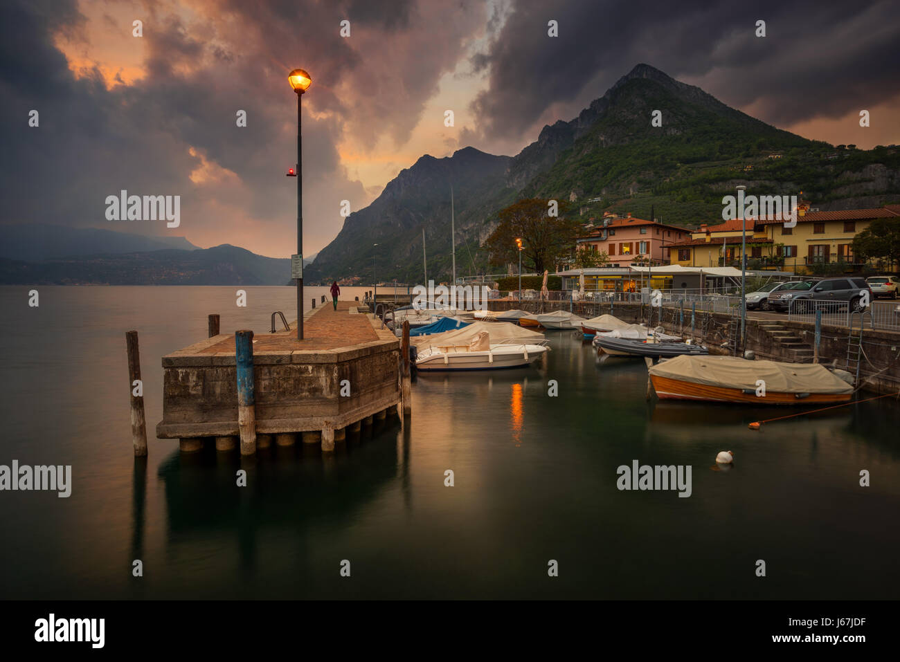 Marone harbour on Iseo Lake with mountains in storm in background ...