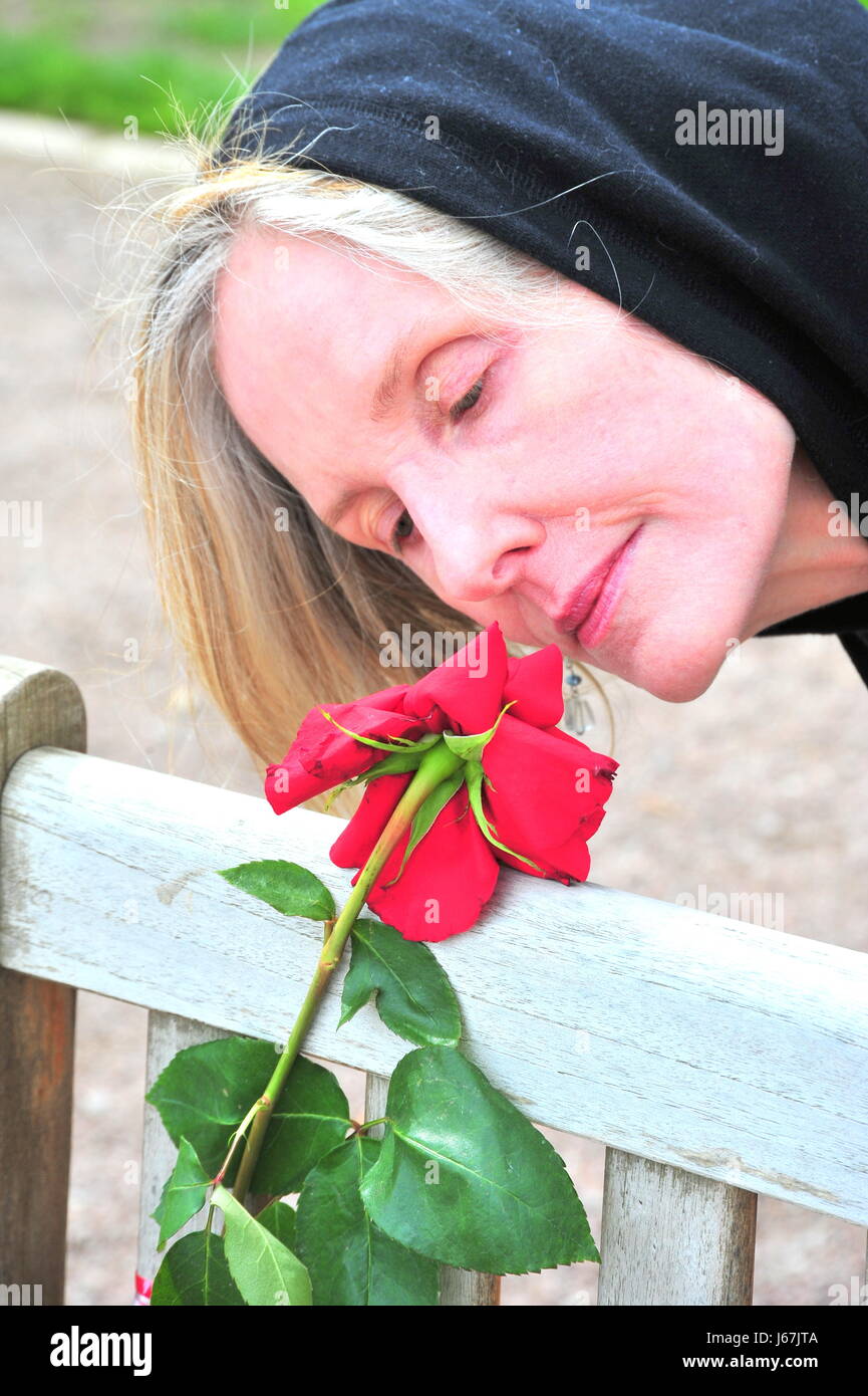 woman female flower plant rose sniff humans human beings people folk ...
