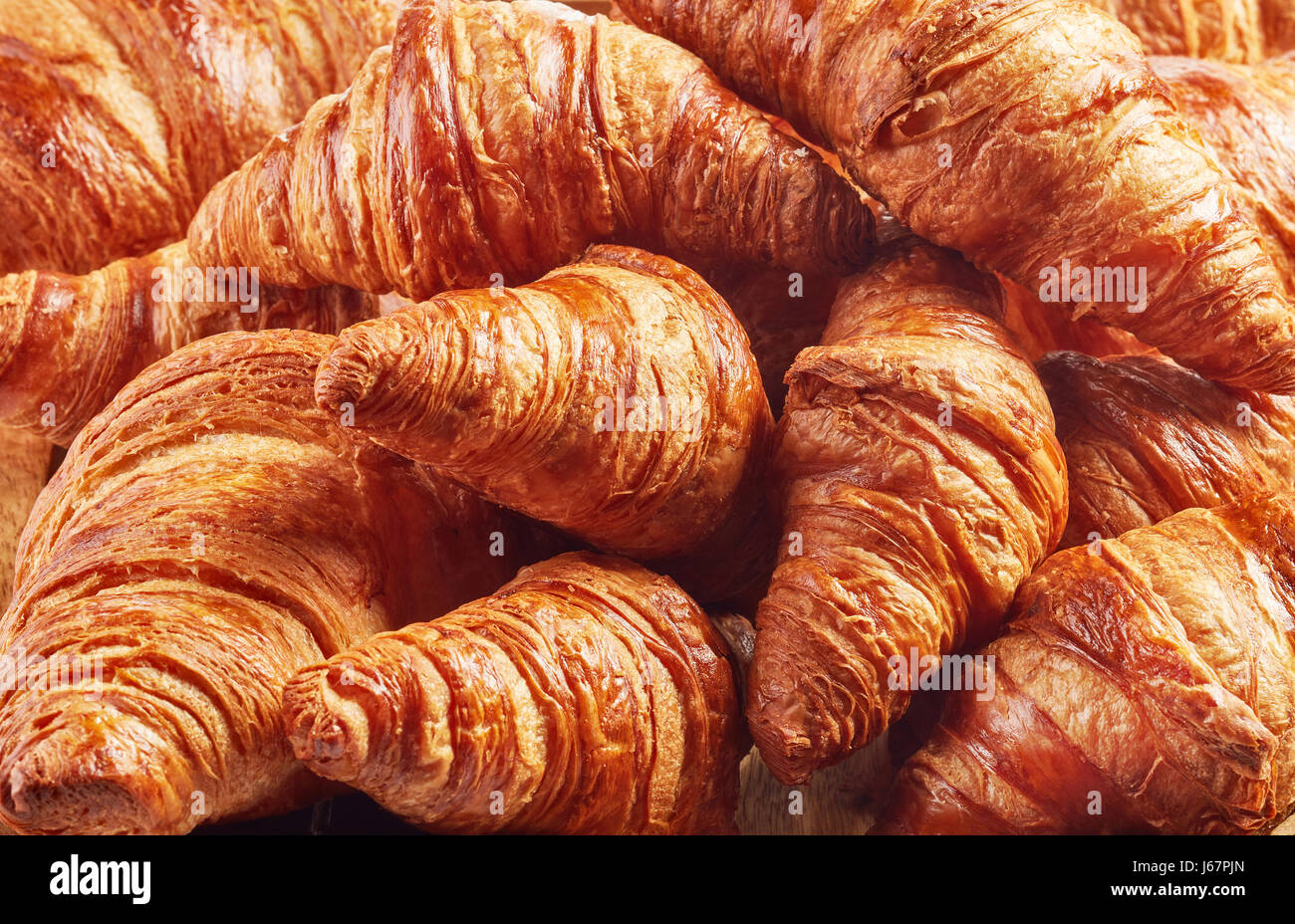 freshly baked crusty croissant background Stock Photo - Alamy