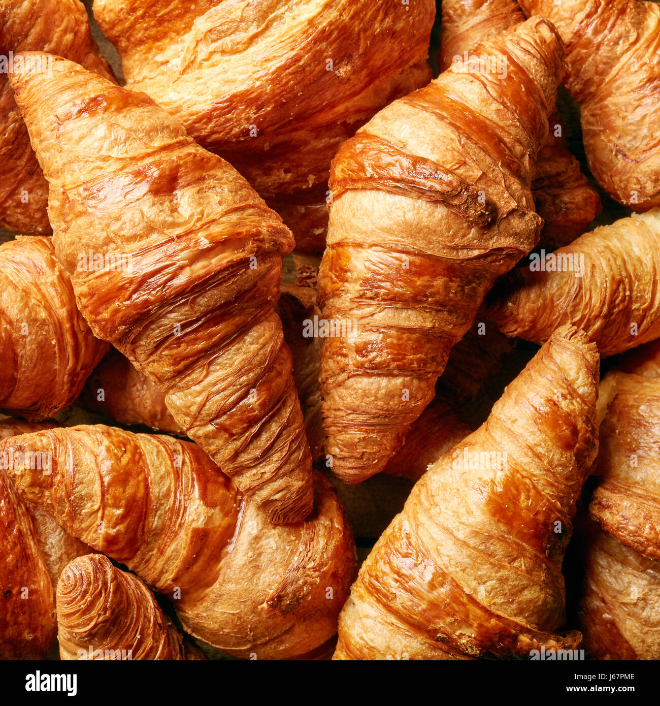 freshly baked crusty croissant background Stock Photo - Alamy