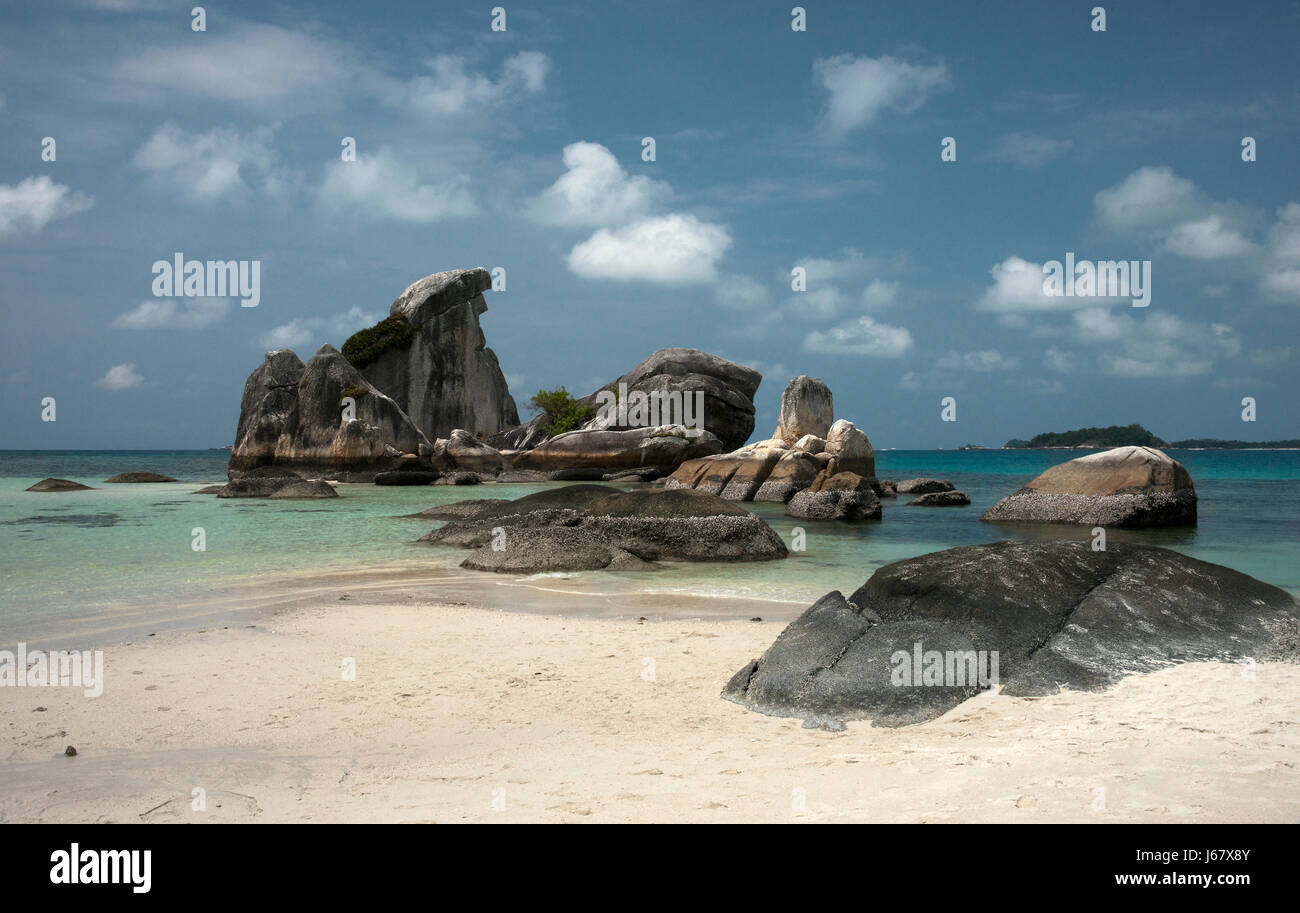 Natural rock formation in the sea and on a white sand beach in Belitung ...