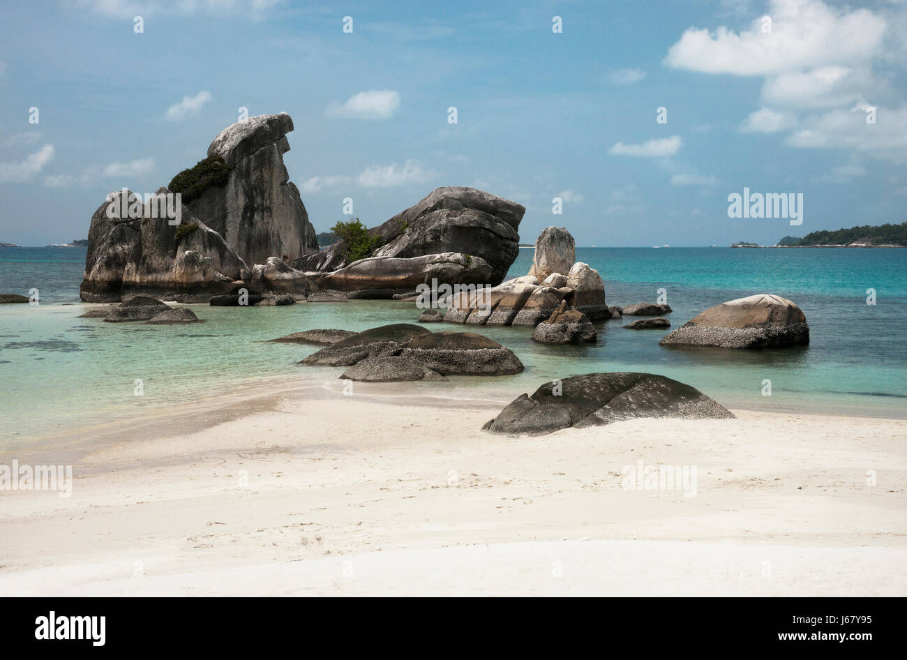 Natural rock formation in the sea and on a white sand beach in Belitung ...