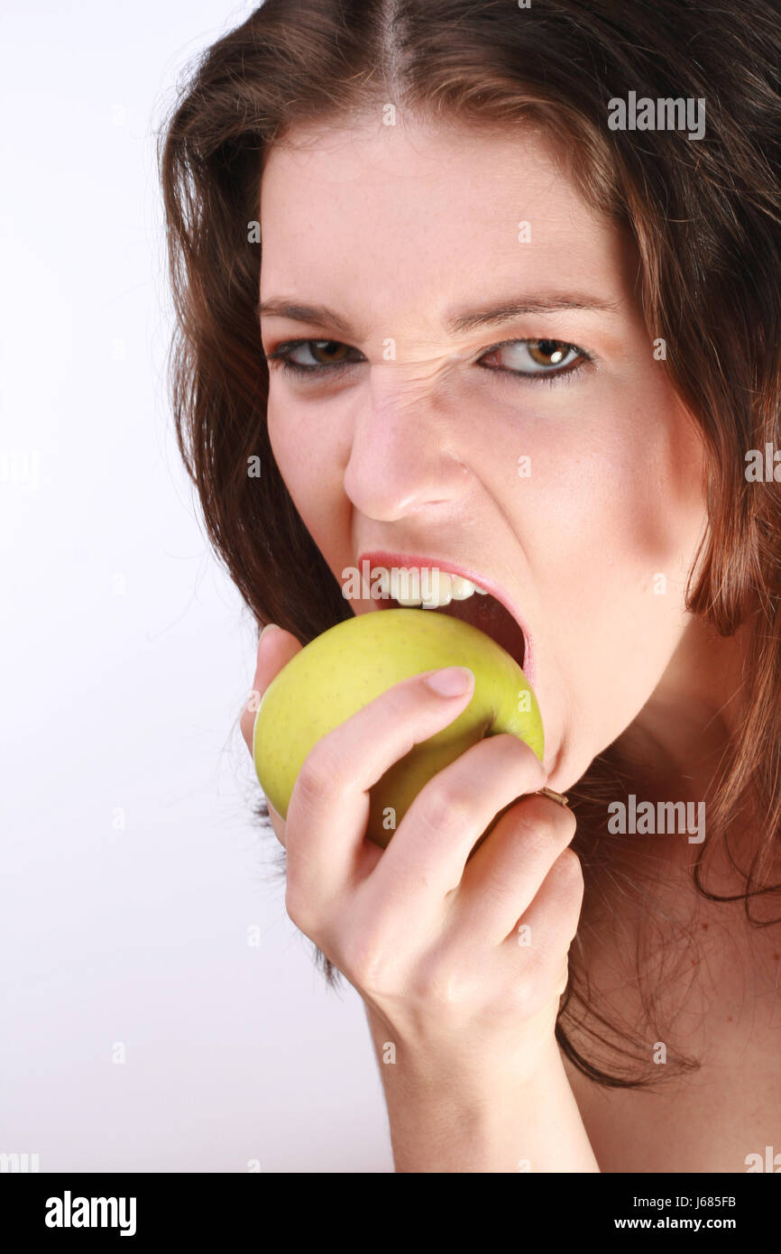young woman biting into green apple Stock Photo - Alamy