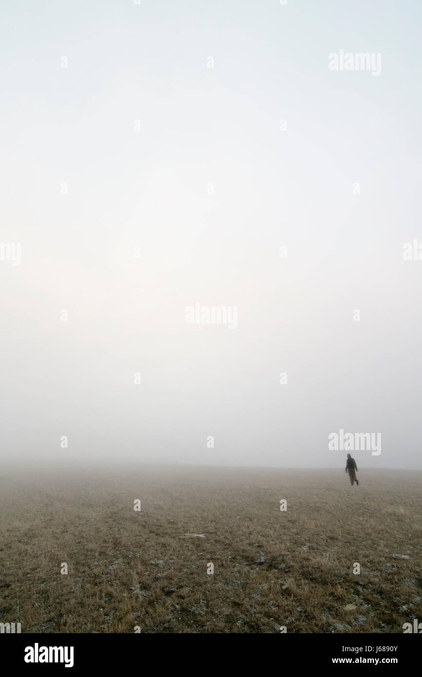 woman walk go going walking female winter male masculine cloud snow ...