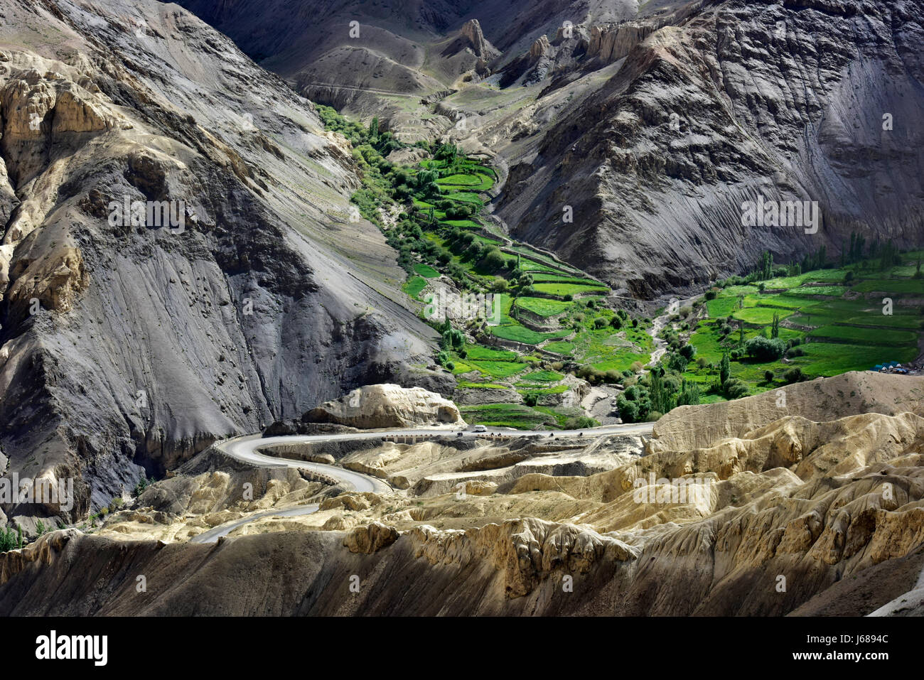 High mountain Tibetan village: among the gray and yellow rocks terraces ...