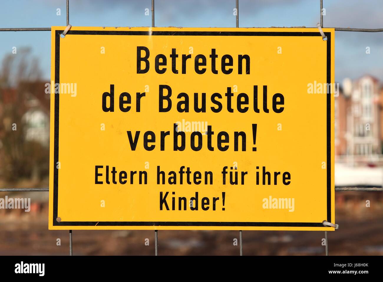 yellow warning sign at German construction site Stock Photo - Alamy