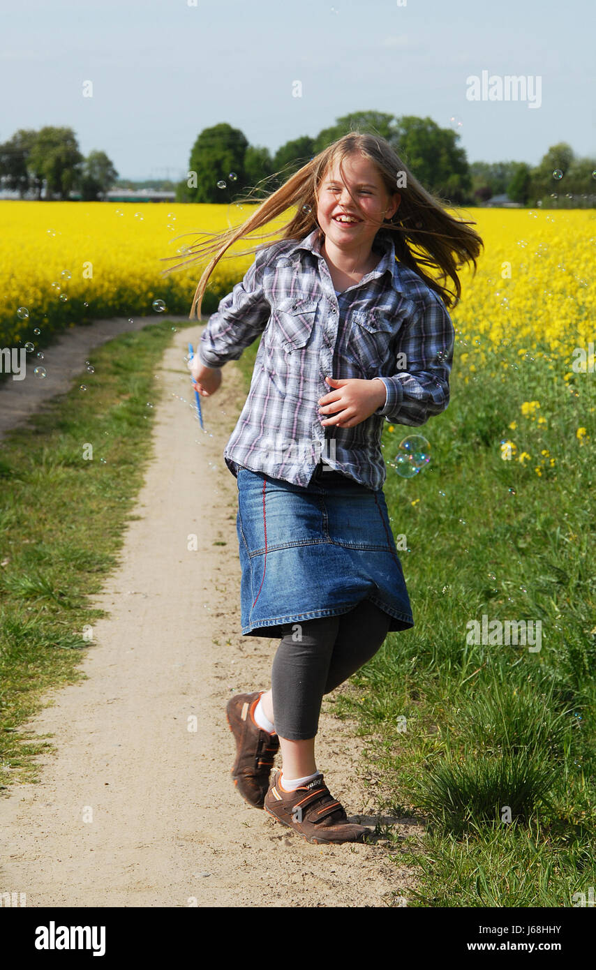 turn twirl field soap bubbles schoolchild child girl girls laugh laughs ...