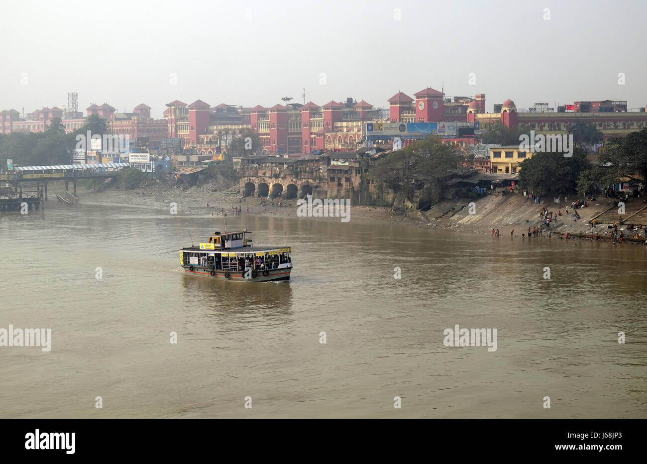 Ferry boat crosses the Hooghly River nearby the Howrah Bridge in ...