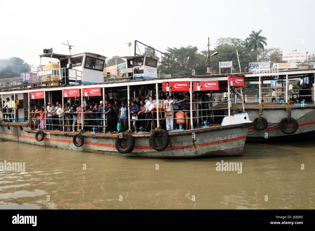 Ferry boat crosses the Hooghly River nearby the Howrah Bridge in ...