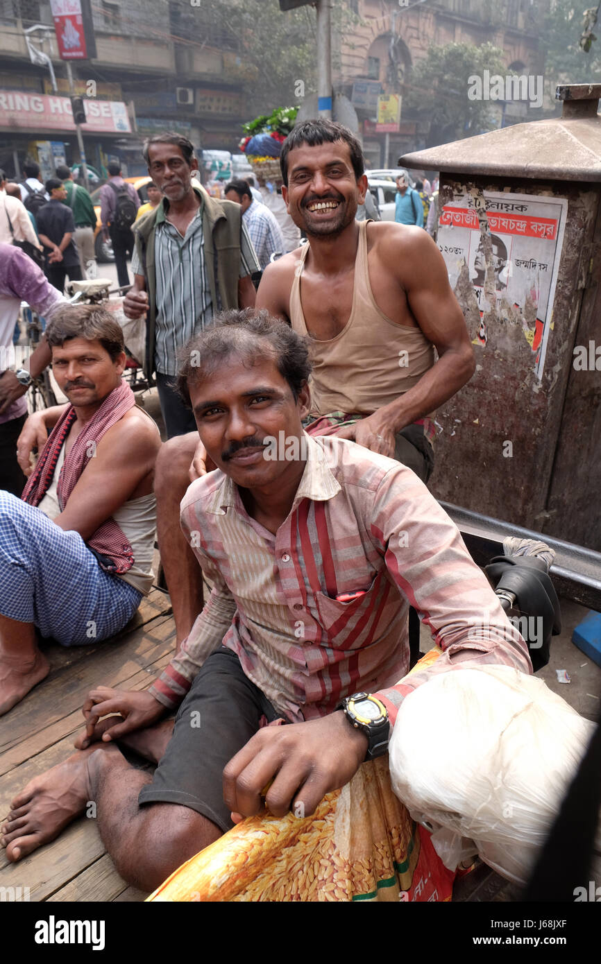 Indian rickshaw drivers posing sitting on tricycle rickshaw in Kolkata ...