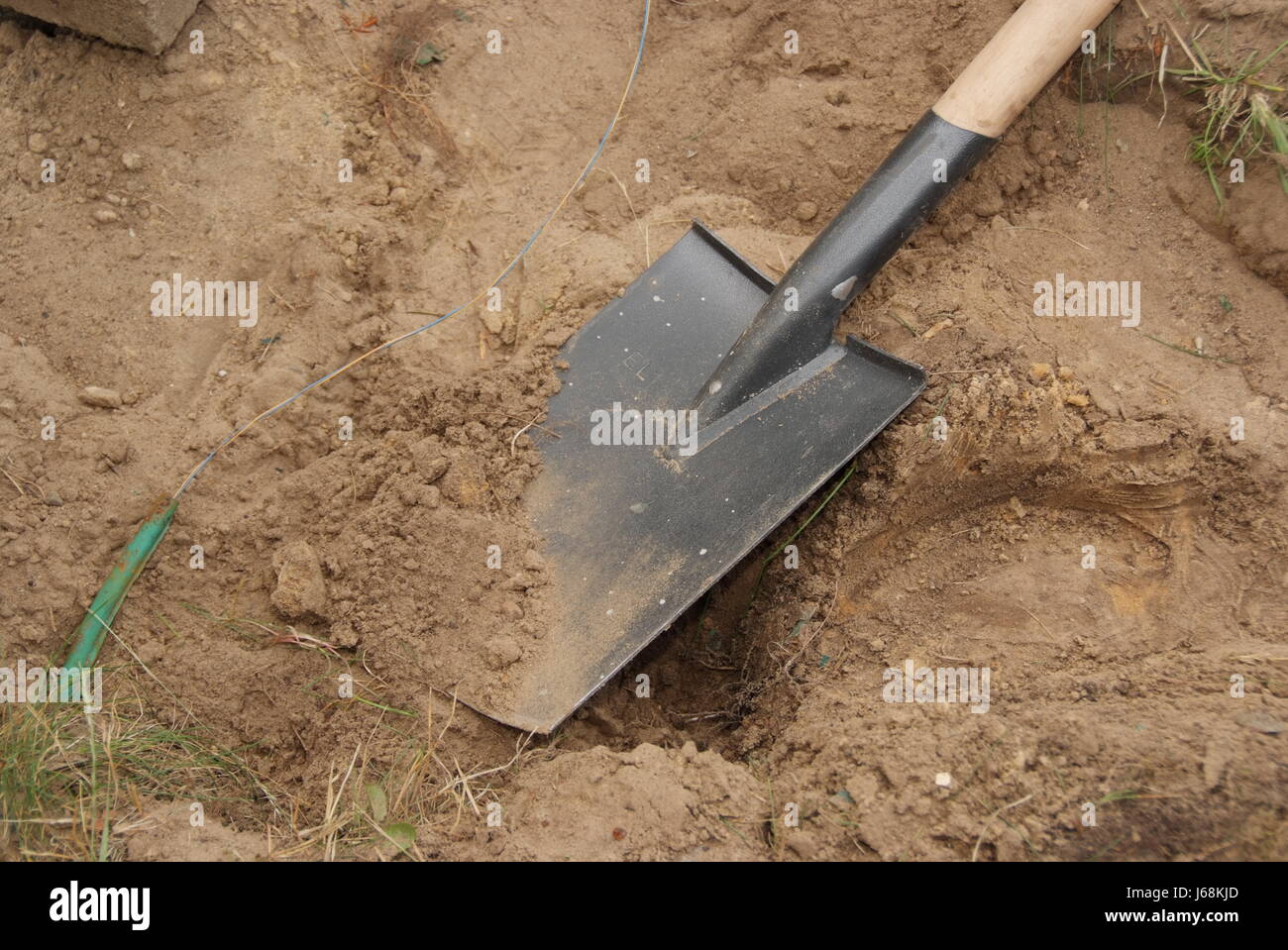 spade in the sand Stock Photo - Alamy