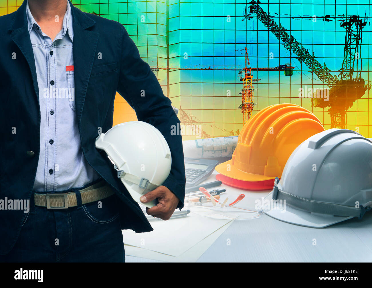 engineering man standing with white safety helmet against building and ...