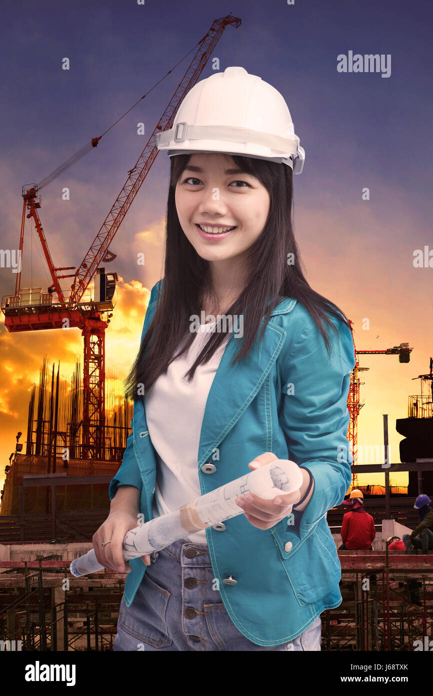 female engineer with construction plant against building stucture site ...