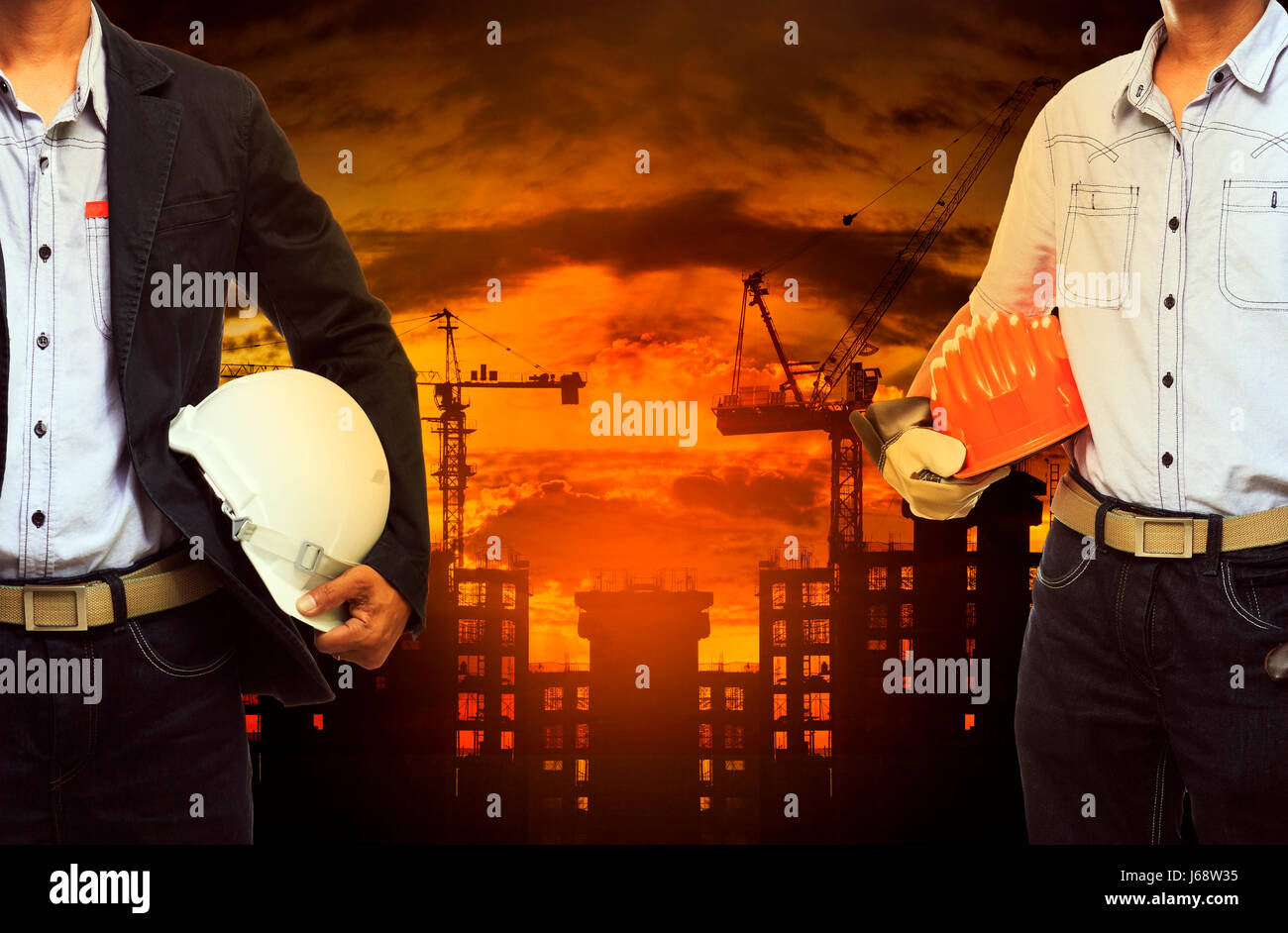 young engineer man standing with safety helmet against building ...