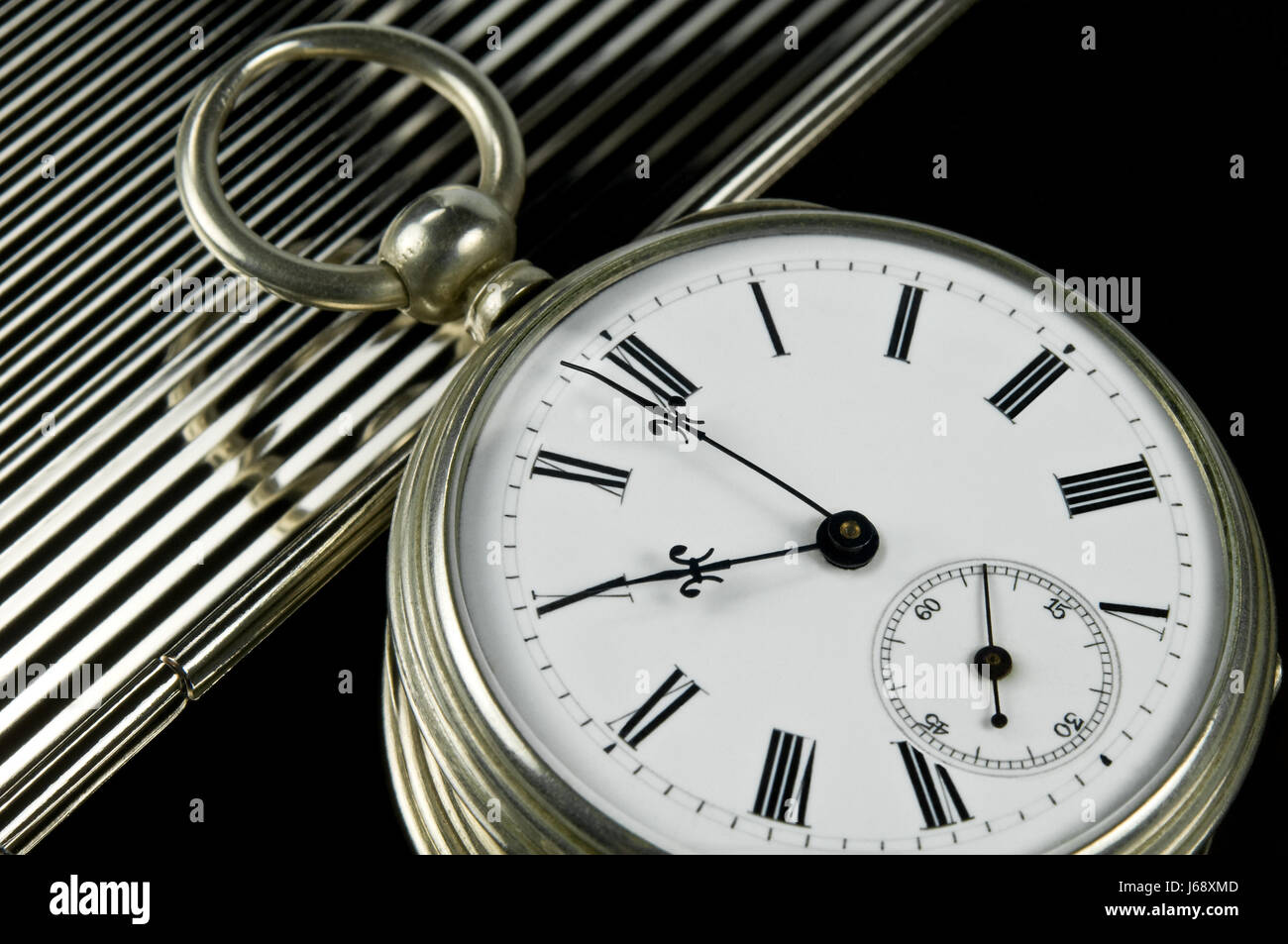 pocket watch on a metal tin Stock Photo - Alamy