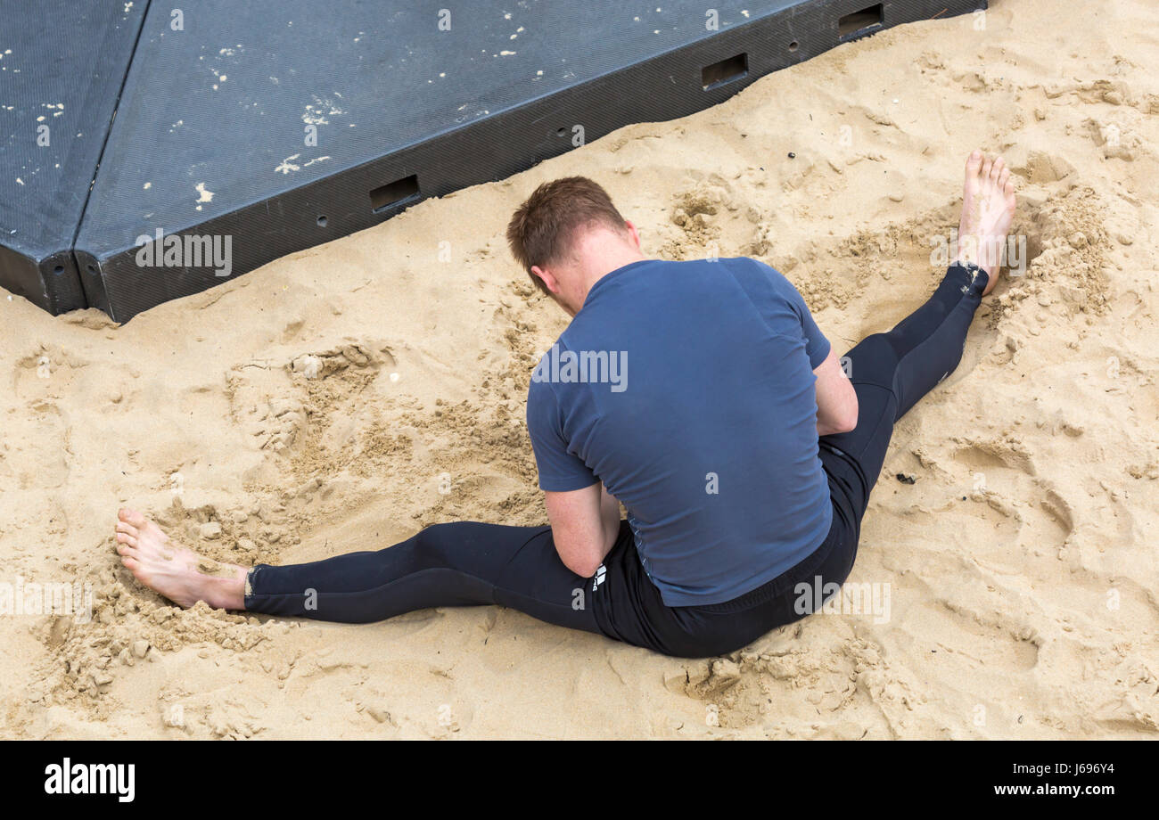 From above man sitting on sand with legs wide apart hi-res stock ...