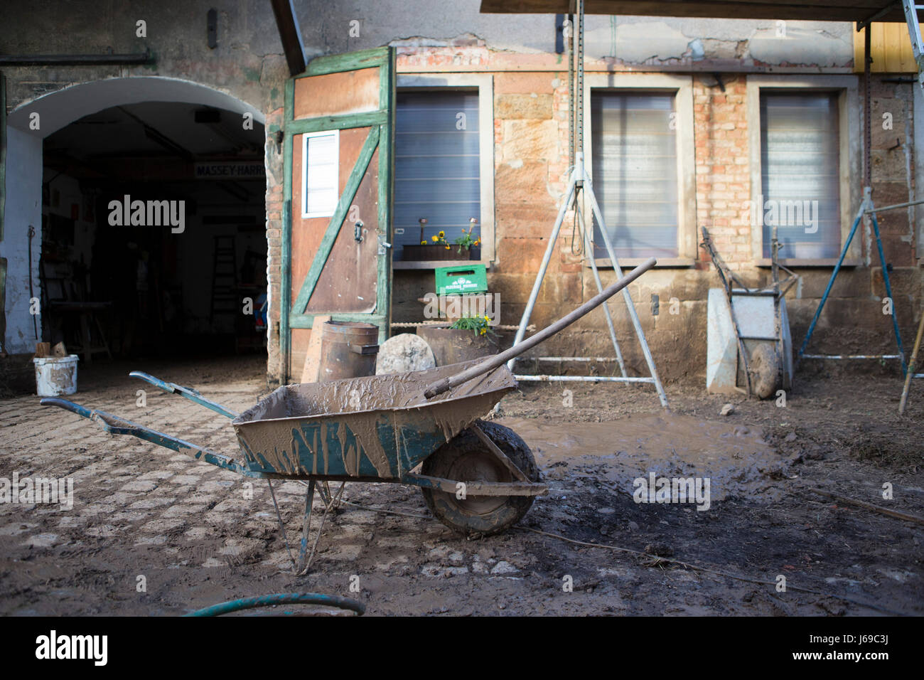 A wheelbarrow filled with mud seen following a heavy storm in Bad Bibra ...
