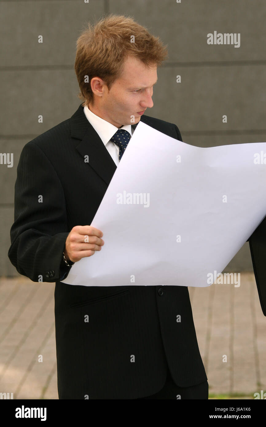 man reading blueprints Stock Photo - Alamy