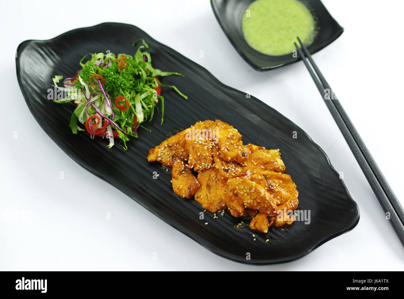 Grilled crocodile with butter chili sauce and salad Stock Photo - Alamy