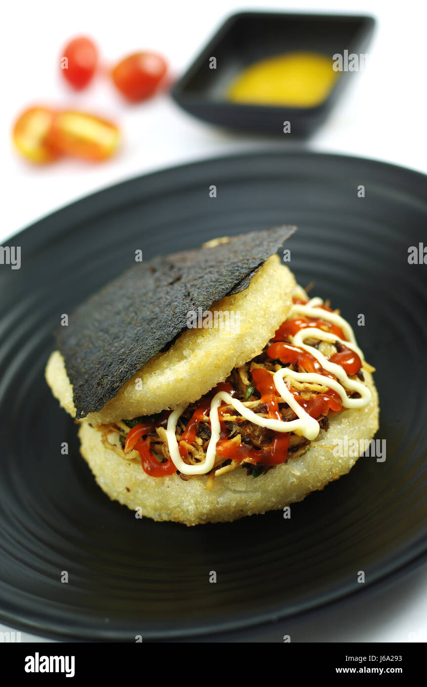 Sticky rice with seaweed and pork on black platter Stock Photo - Alamy