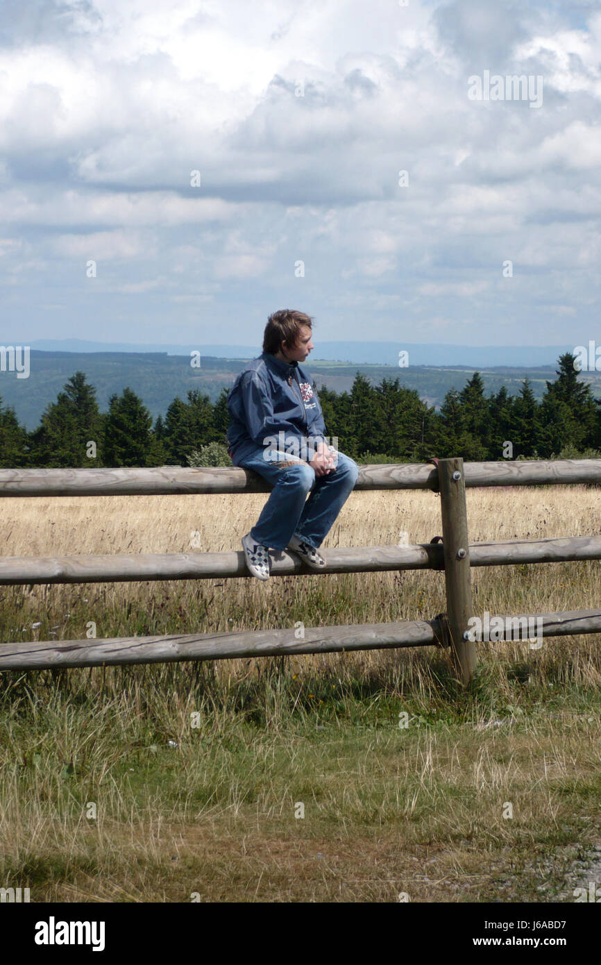 sits railing young younger child forest nature clouds wait waiting tree ...