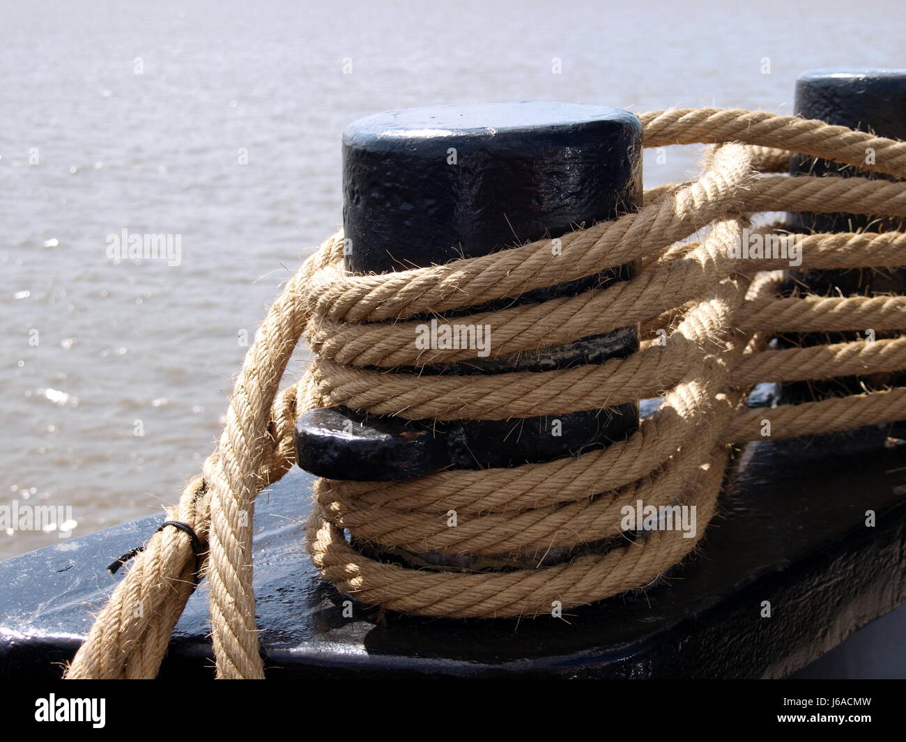 bollard with rope Stock Photo - Alamy