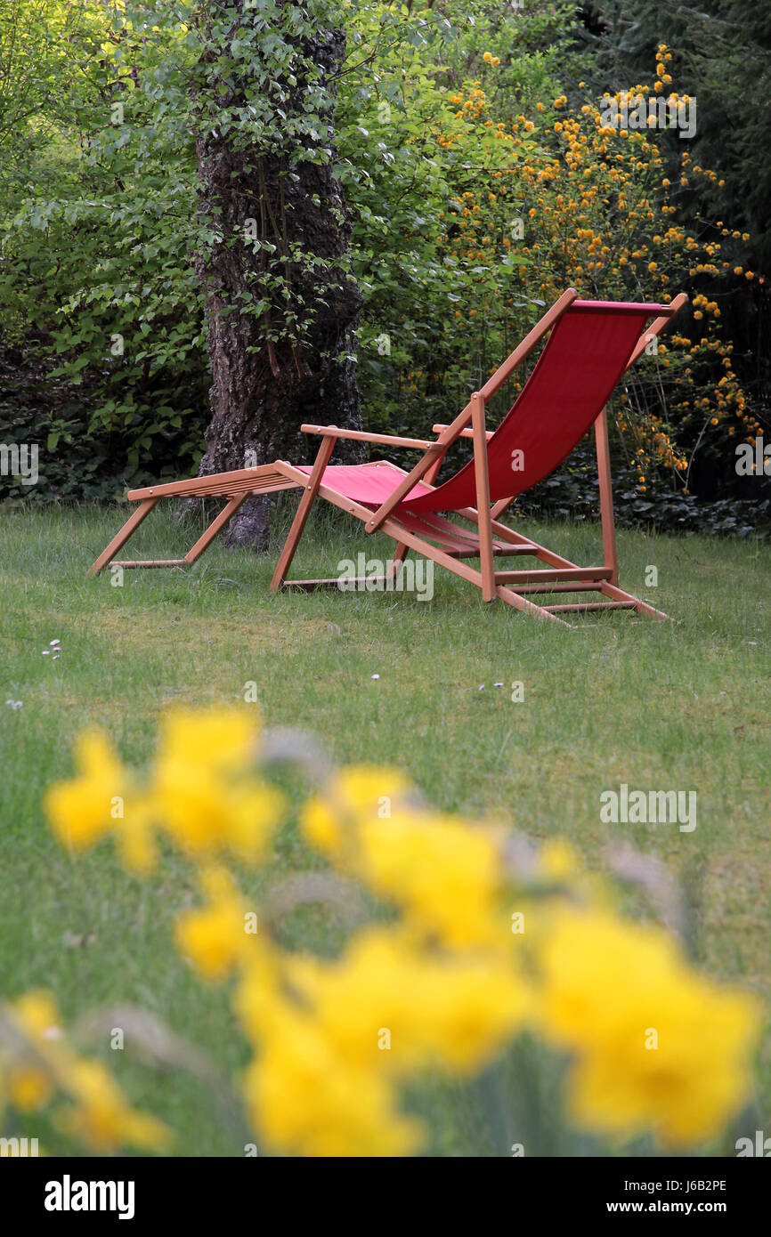 red deck chair in the garden Stock Photo - Alamy