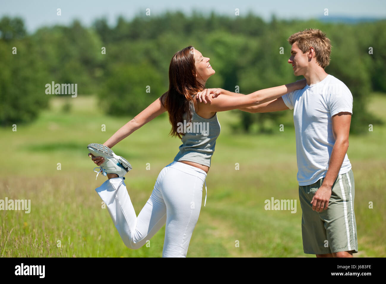 woman summer summerly sunlight exercise meadow couple pair exercising ...