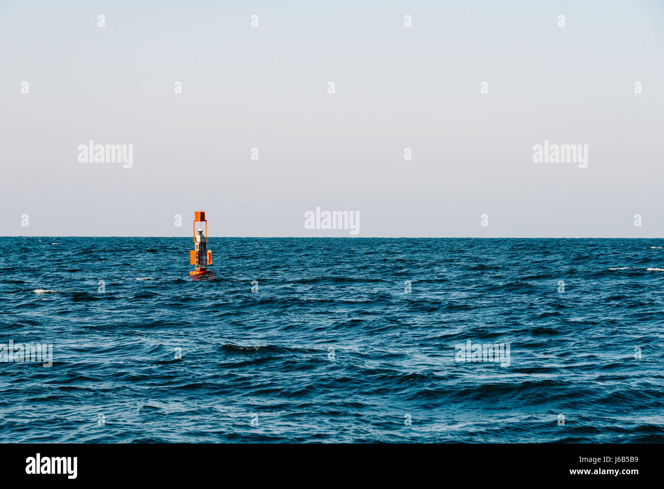 Red Warning Light Floating In The Middle Of The Ocean Stock Photo - Alamy
