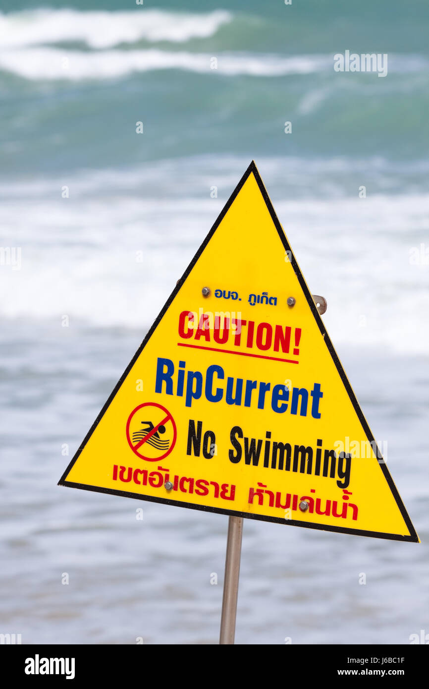 warning sign with note on the beach Stock Photo - Alamy