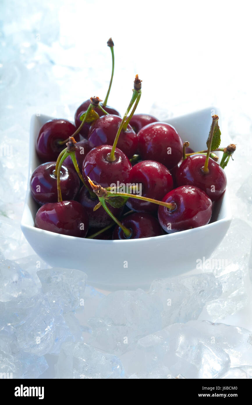 frozen cherry on ice cubes Stock Photo - Alamy