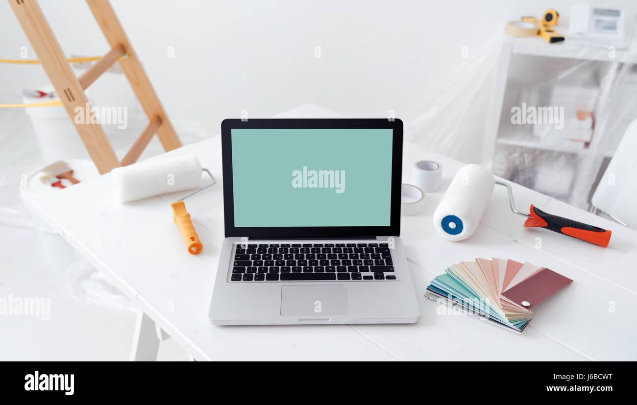 Home makeover, renovation and decoration: laptop on a desktop with ...