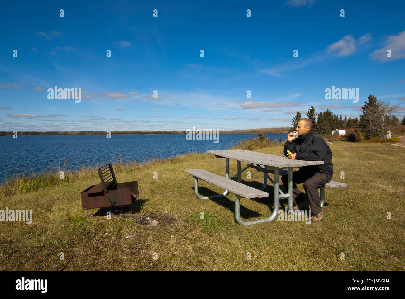 Hiker at picnic area near Lake Audy, Riding Mountain National Park ...