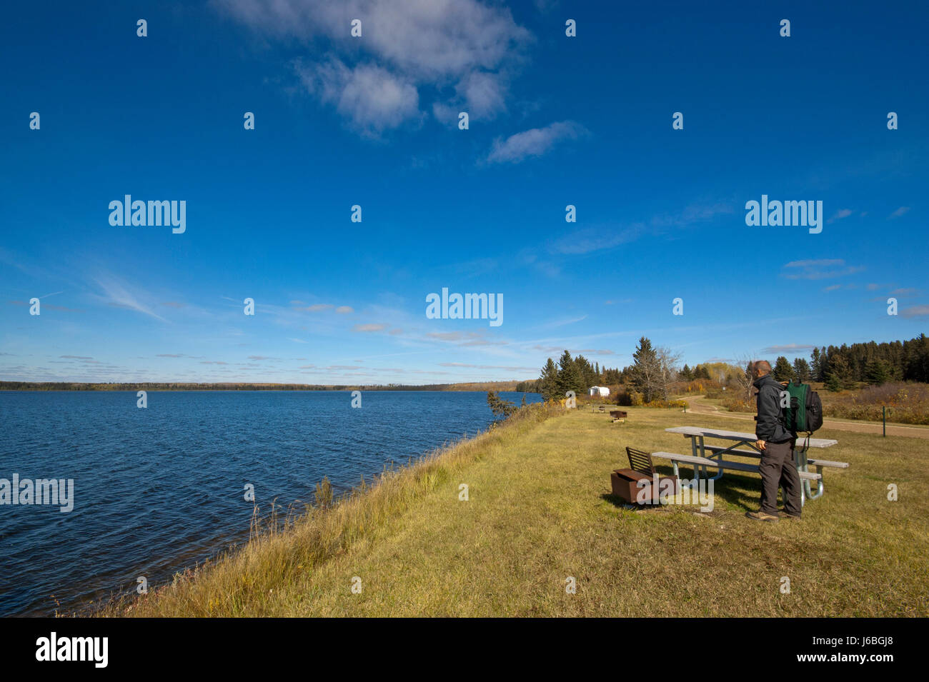 Hiker at picnic area near Lake Audy, Riding Mountain National Park ...