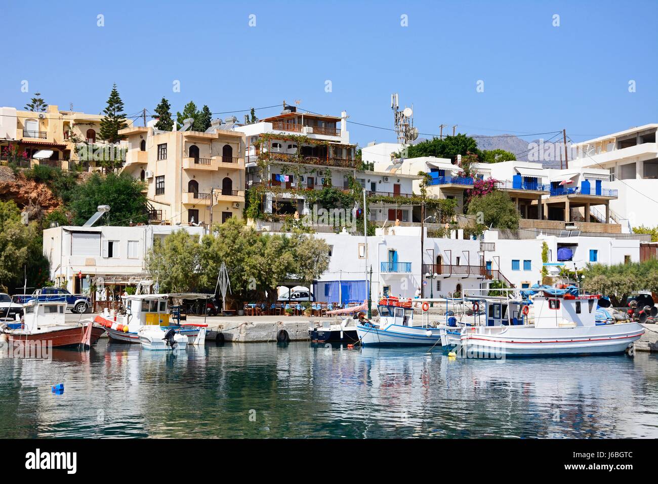 Traditional fishing boats in the harbour with town buildings to the ...