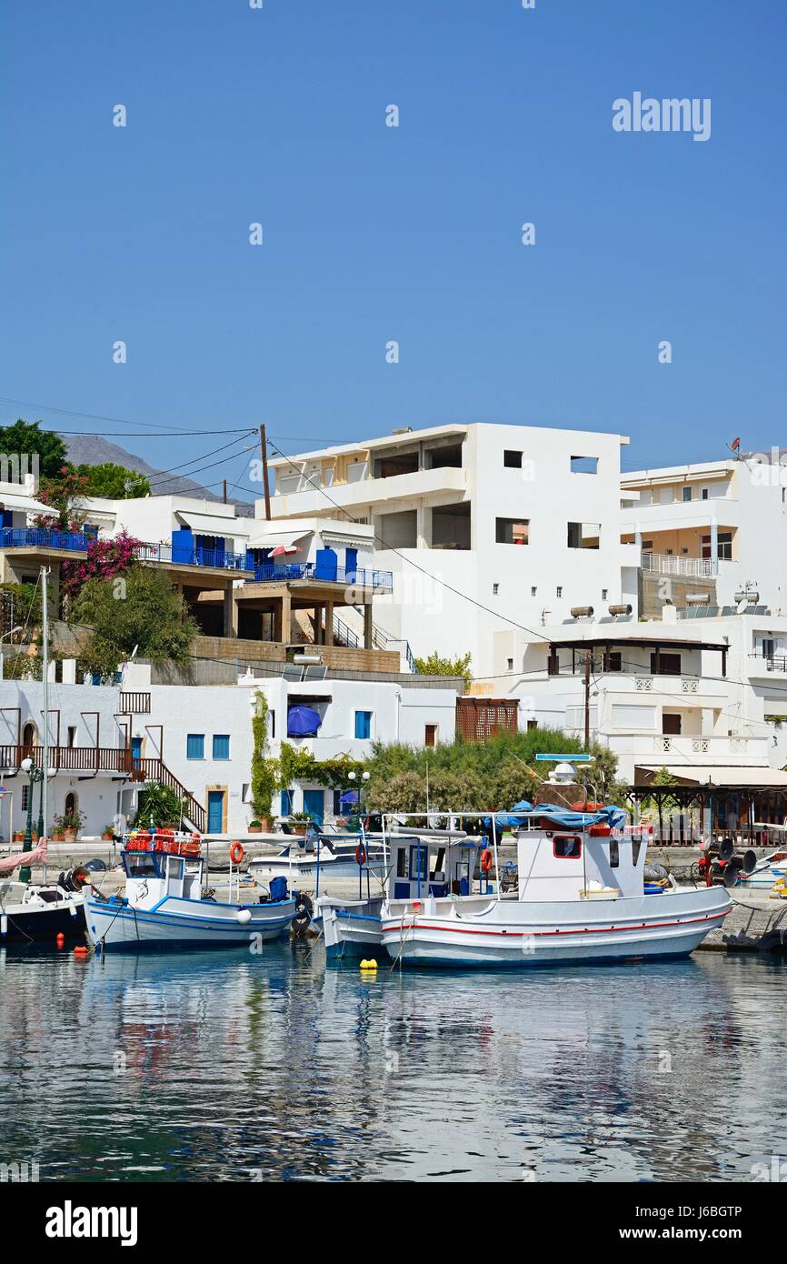 Traditional fishing boats in the harbour with town buildings to the ...