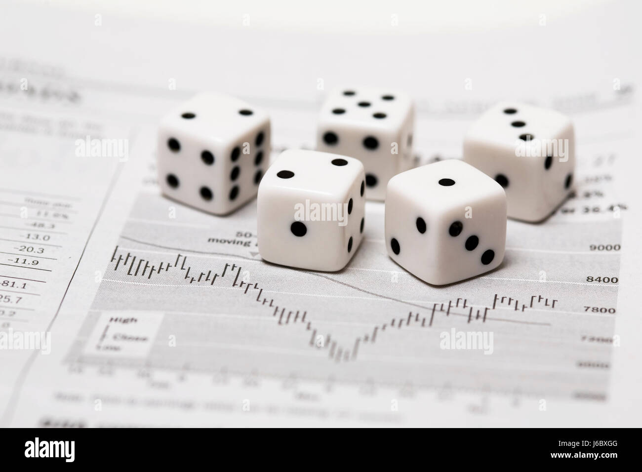 dice on stock market magazine Stock Photo - Alamy