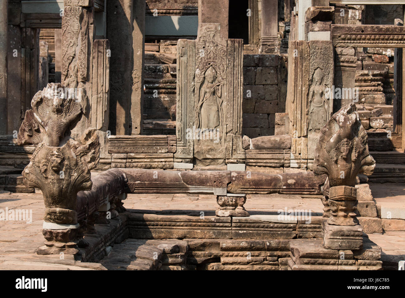 A restored and unrestored stone carving of the mythical shesh nag at ...