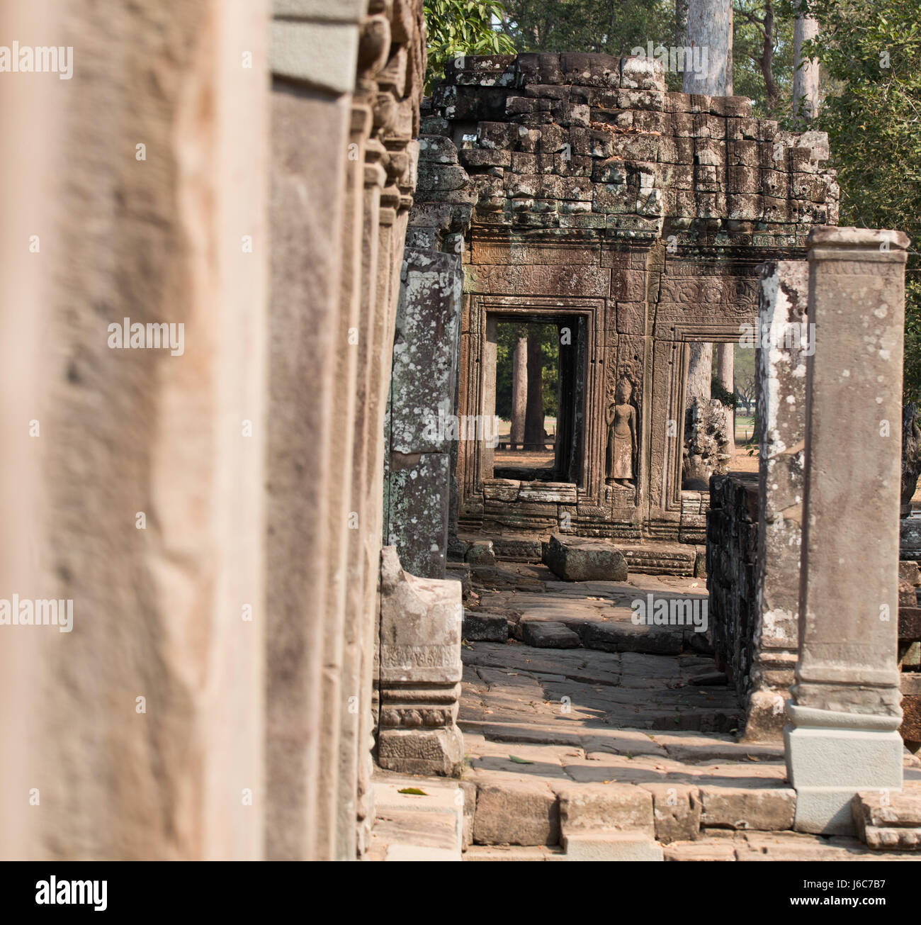 An apsara, heavenly nymph, stands at the end of a gallery at Bayon ...