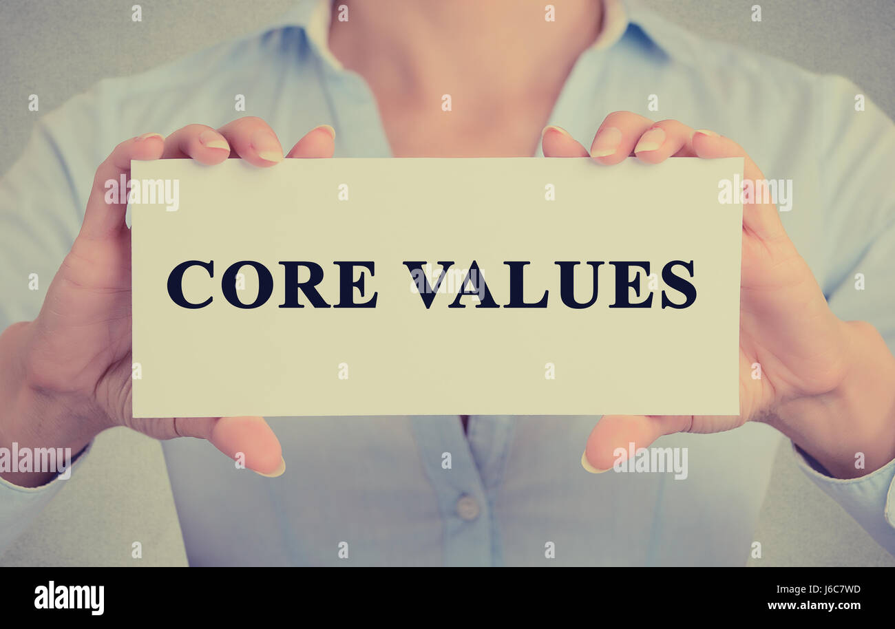 Closeup businesswoman hands holding white card sign with core values ...