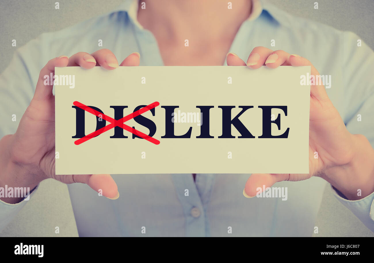 Closeup businesswoman hands holding white card sign with dis crossed in ...