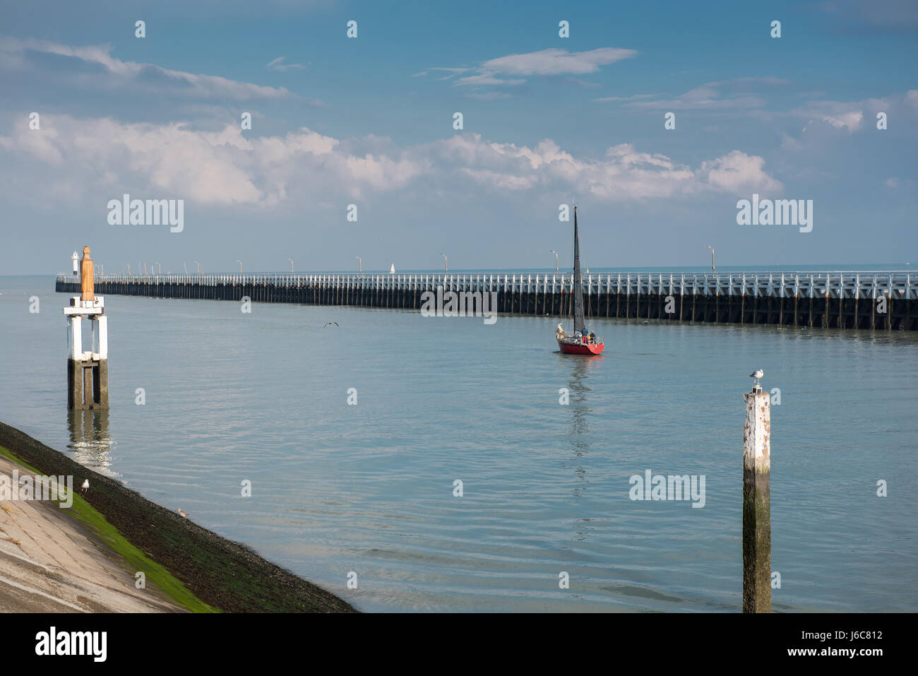Sailboat is going trough the canal to the sea Stock Photo - Alamy