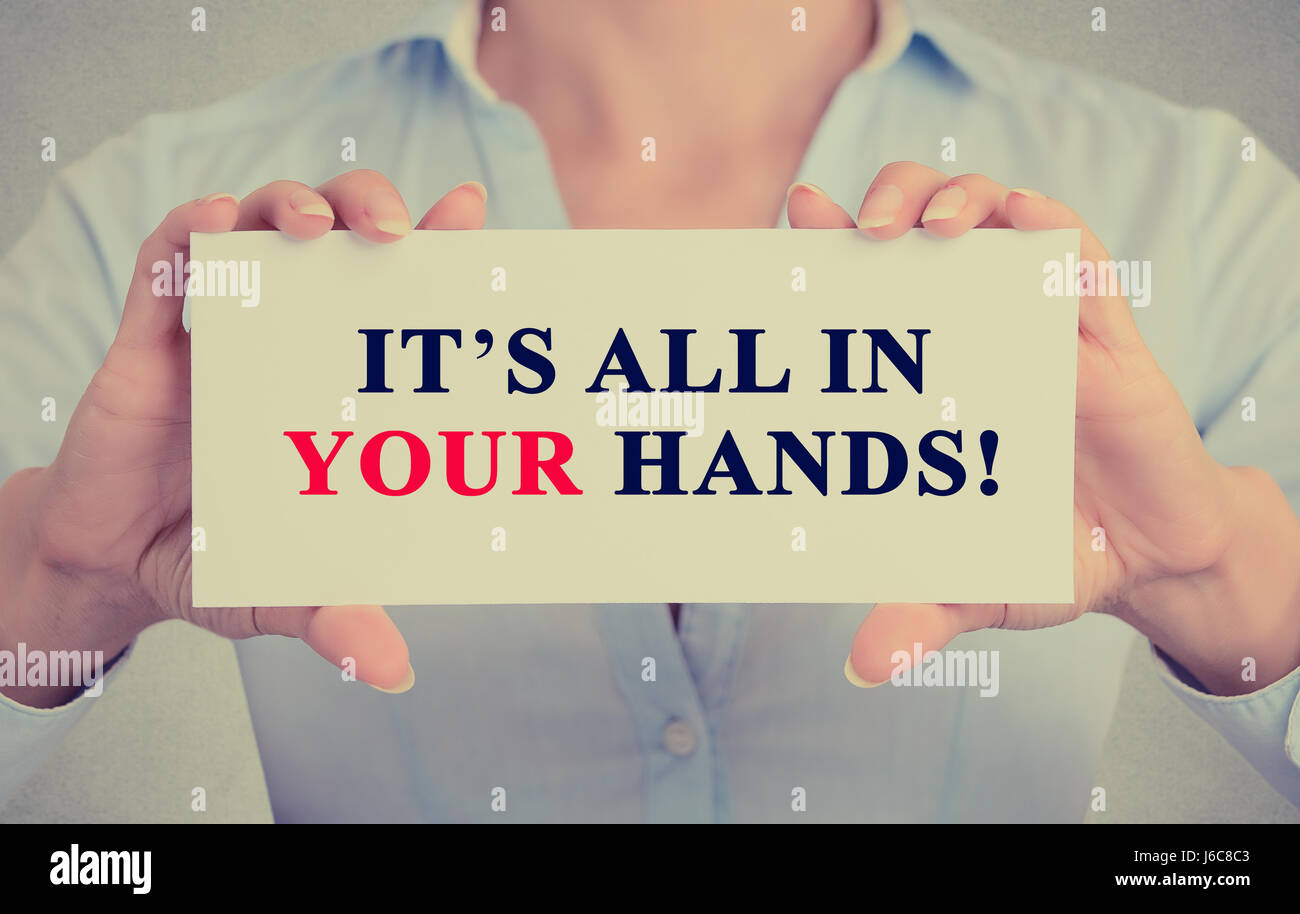 Image of businesswoman hands holding white card with It's All in Your ...