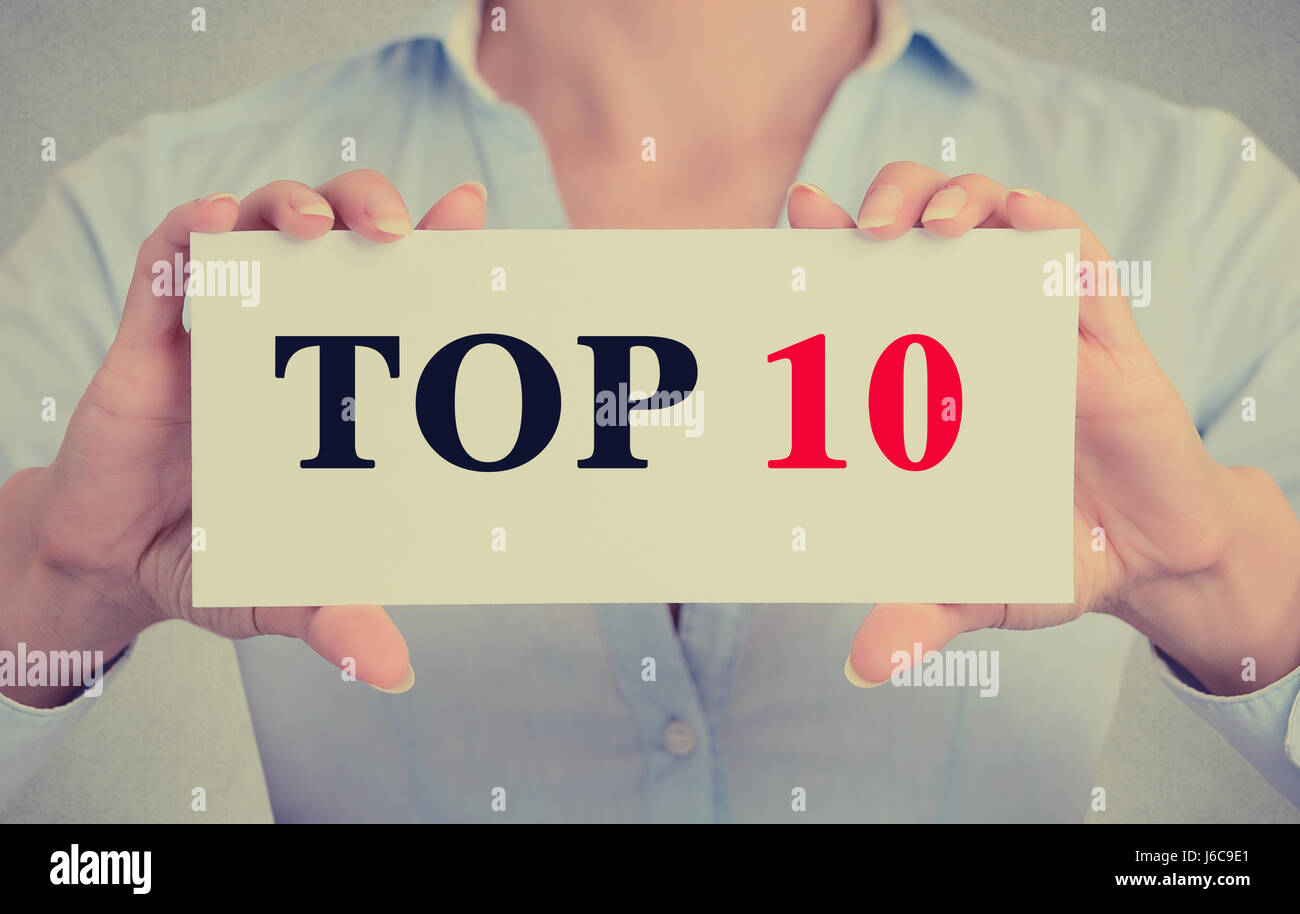 Closeup businesswoman hands holding white card sign with top 10 text ...