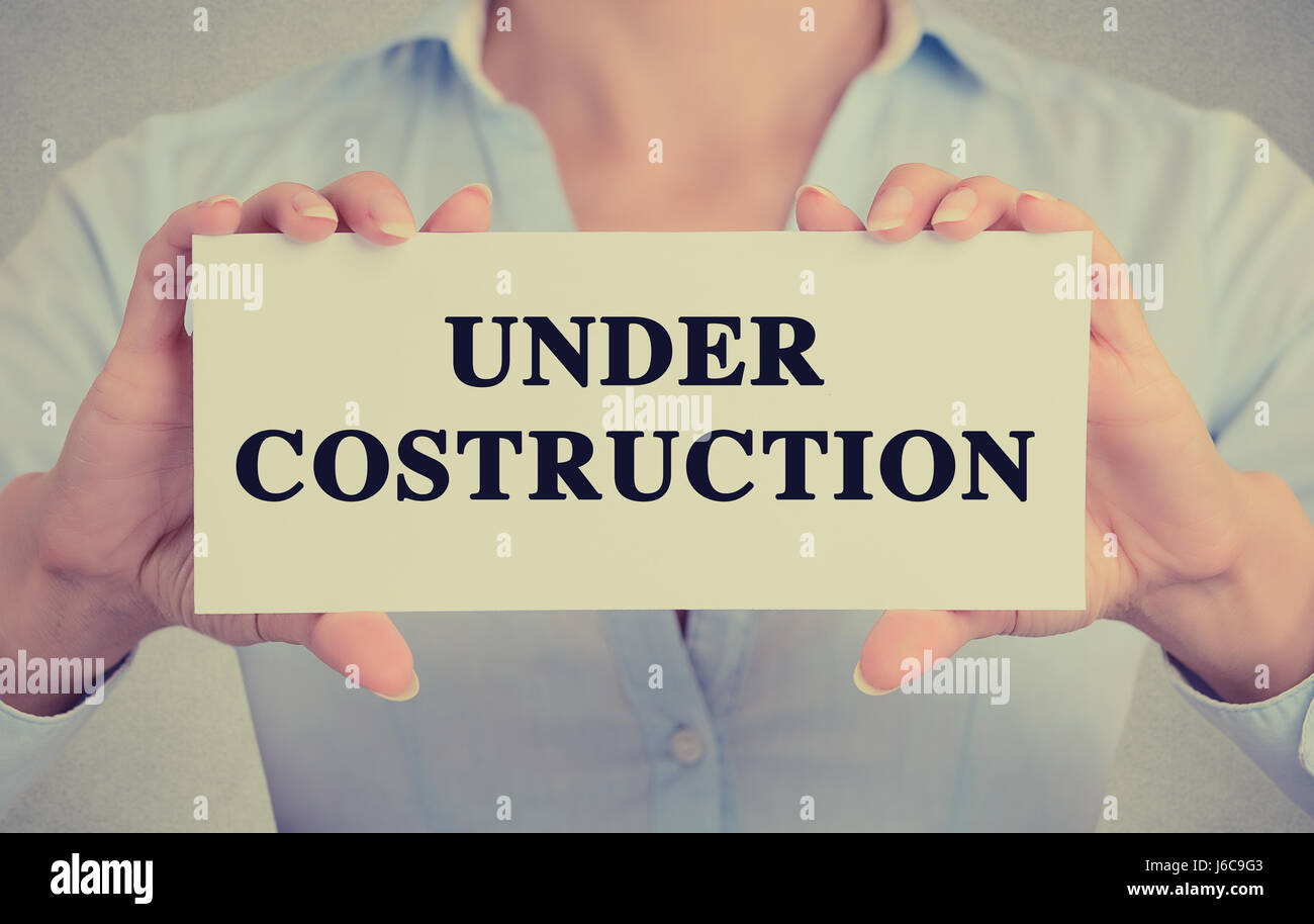 Closeup businesswoman hands holding white card sign with under ...