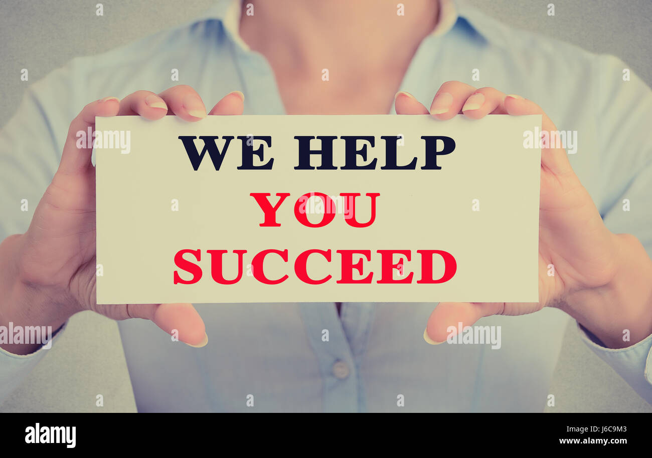 Businesswoman hands holding white card sign with we help you succeed ...