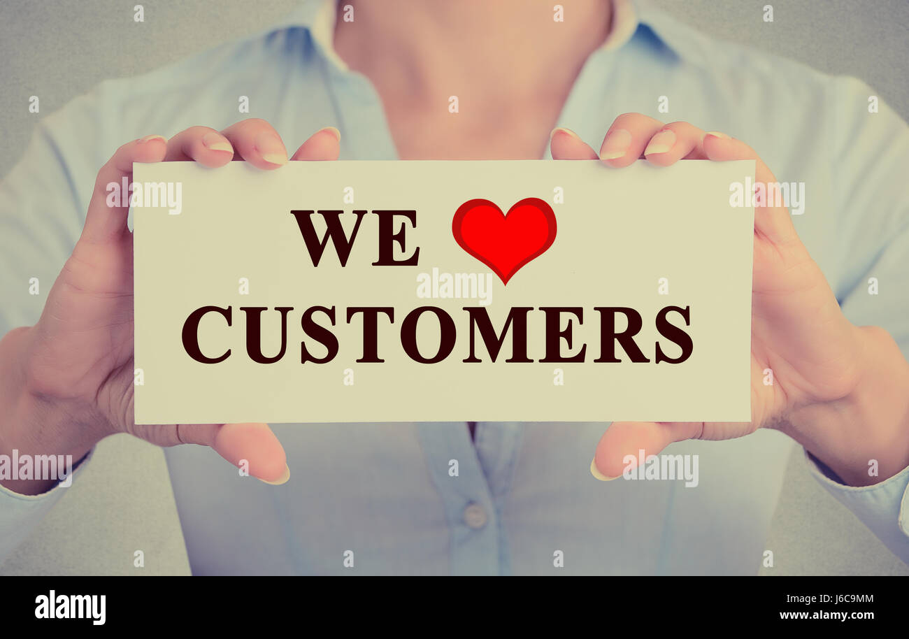 Closeup retro image businesswoman hands holding white sign or card with ...