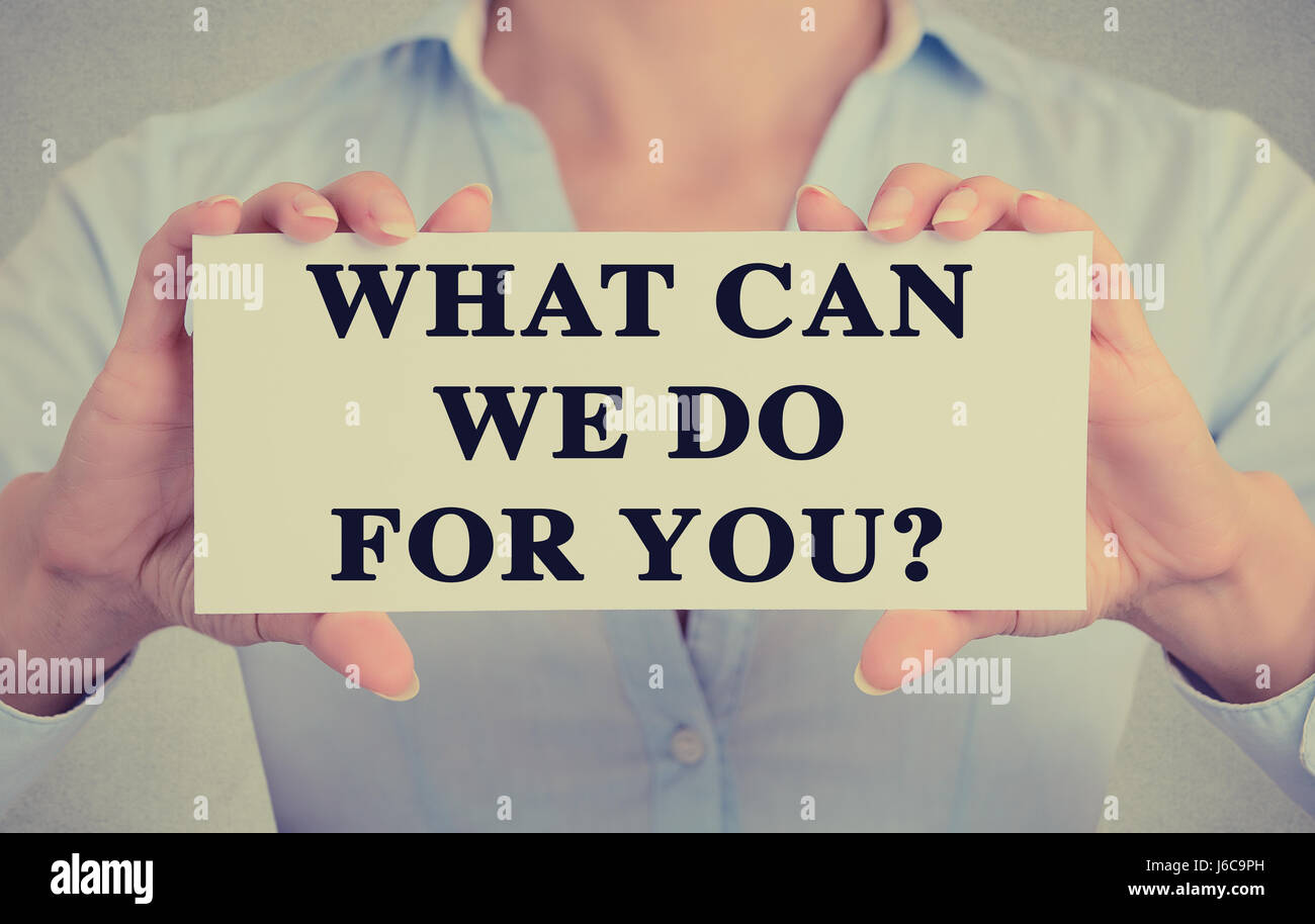 Businesswoman hands holding white card sign with What can we do for you ...
