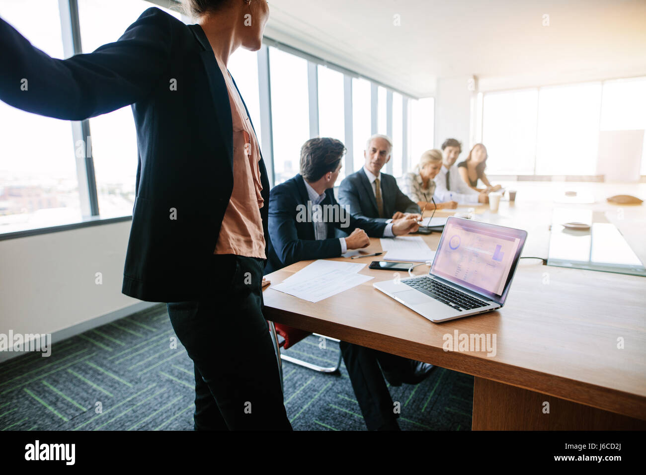 Corporate professionals have meeting in conference room and discussing ...