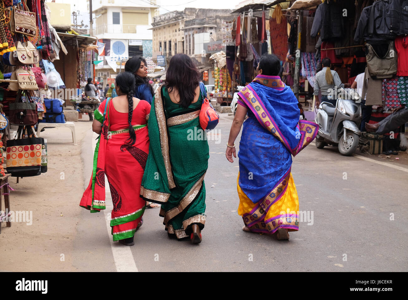 Indian women with traditional colored sari on the street of Pushkar ...